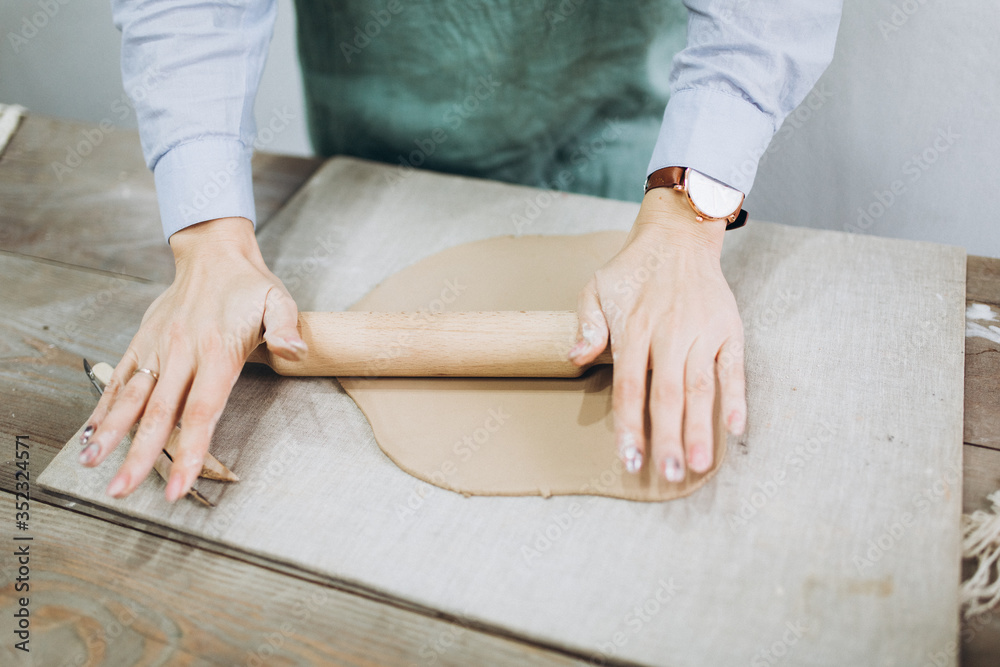 The potter's hands are shaped a cup from a clay. The process of ...