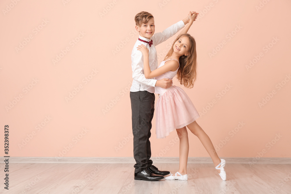 Cute little children dancing against color wall Stock Photo | Adobe Stock