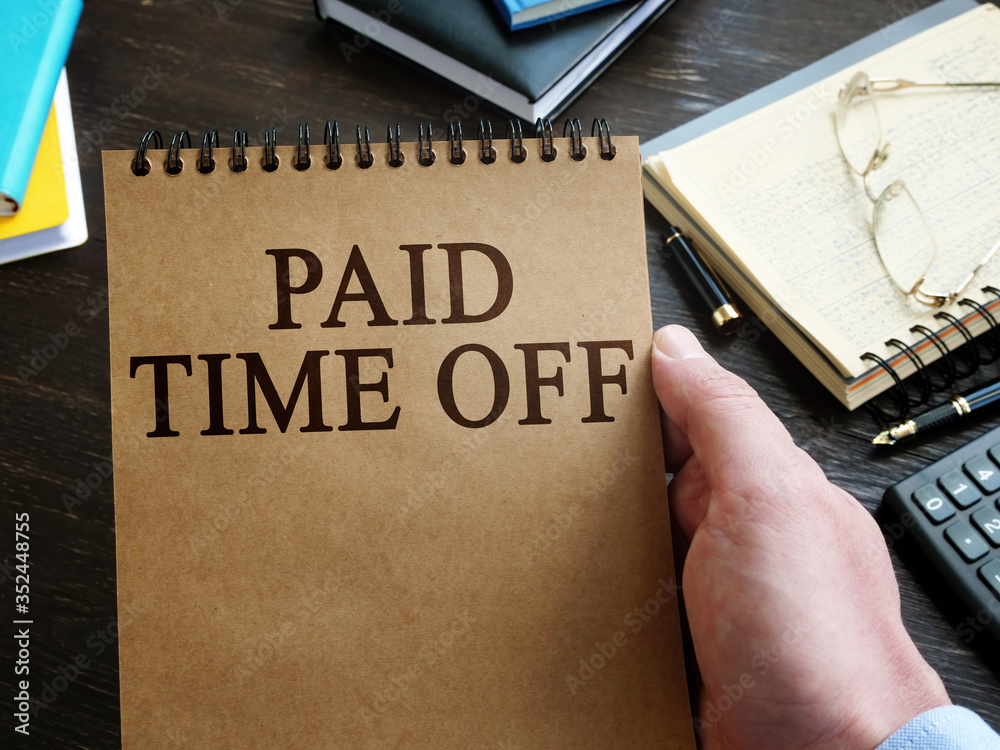 Man holds Paid Time Off PTO policy. Stock Photo | Adobe Stock