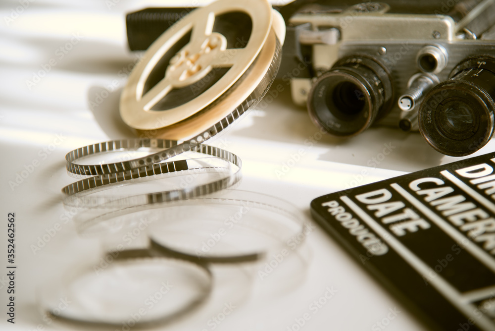 8mm movie roll of film reel with a retro movie camera on a light table ...
