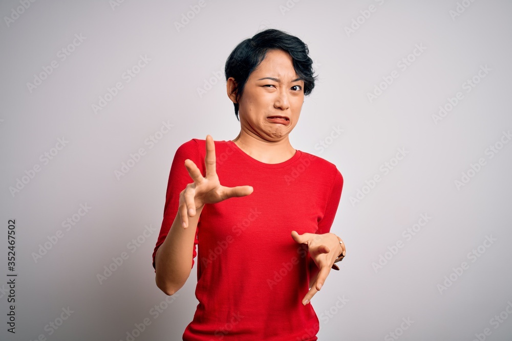 Young beautiful asian girl wearing casual red t-shirt standing over ...