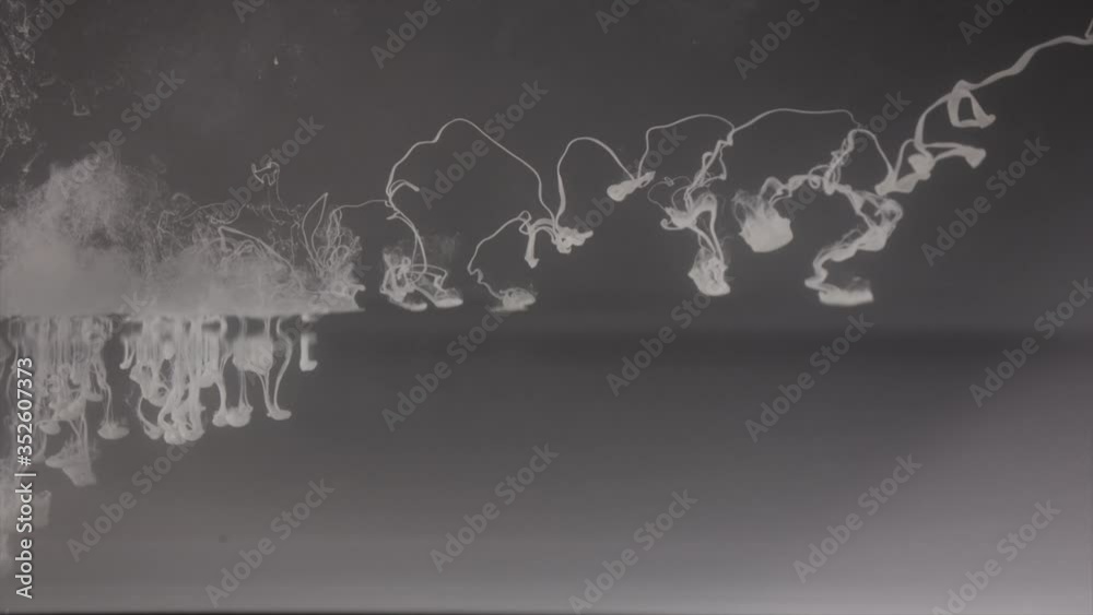 Cloud tank with rolling fog and ink shot against black, on and in water ...
