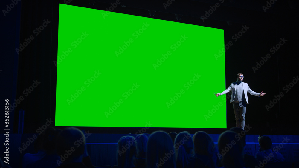 Keynote Speaker Announces New Product to the Audience, Behind Him Movie ...