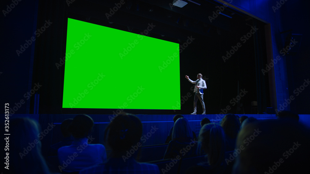 Keynote Speaker Announces New Product to the Audience, Behind Him Movie ...
