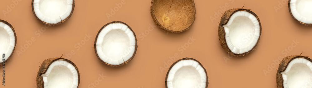 Creative layout with coconuts pattern. Whole and half coconut on brown ...