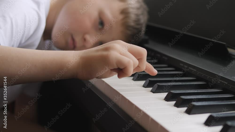 Electronic piano. Fingers press the piano keys. Music lesson. Child was ...