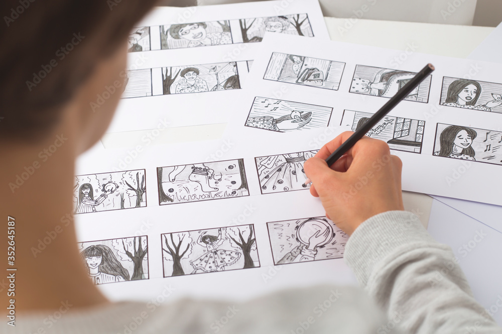 Foto de The hands of an illustrator painter draw a storyboard for a ...