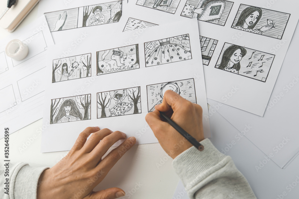 Hands of the artist draw a storyboard on paper. Storytelling. Story ...