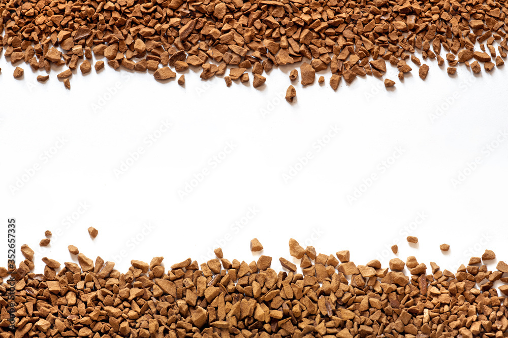 golden color freeze dried coffee, instant coffee granules on a white ...