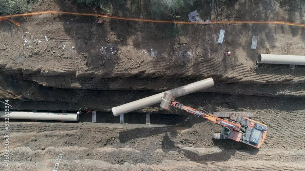 Video „Aerial view of orange or red excavator tractor digging the sand ...