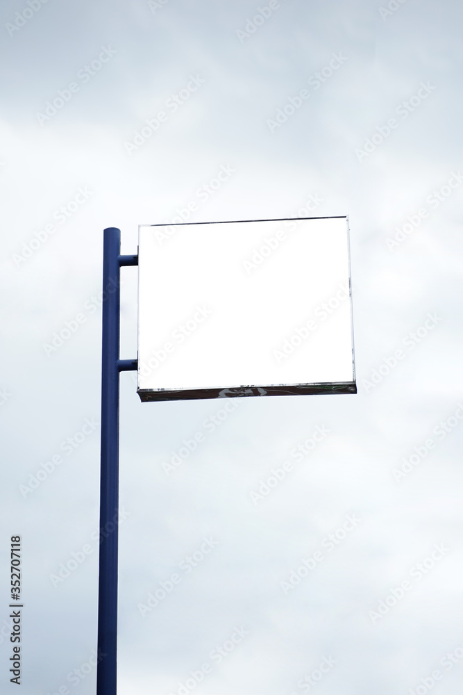 Square billboard with beautiful dusk clouds in the background. The ...