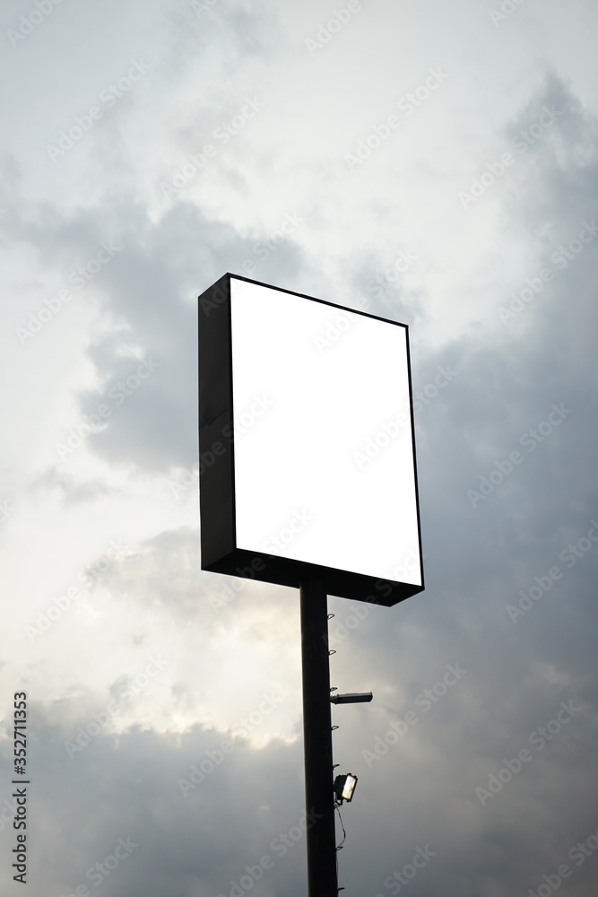 Square billboard with beautiful dusk clouds in the background. The ...