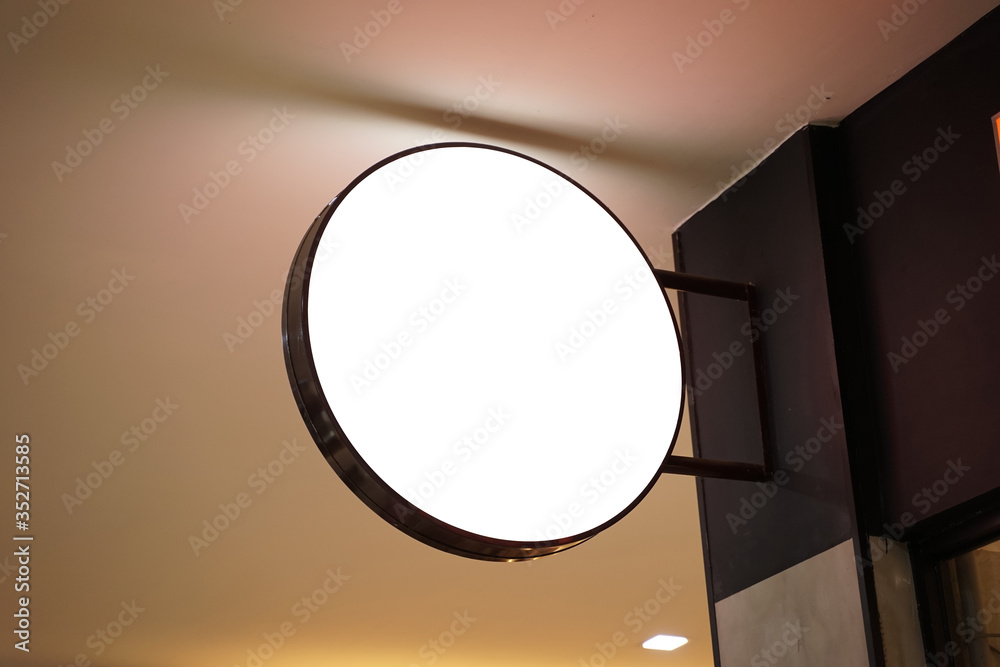 The circular billboard hangs on the shop wall in the mall. Used to ...