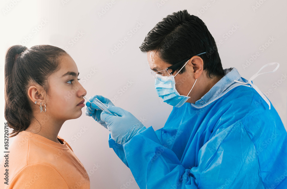 Doctor taking a nasal sample for an examination to a teenage girl Stock ...