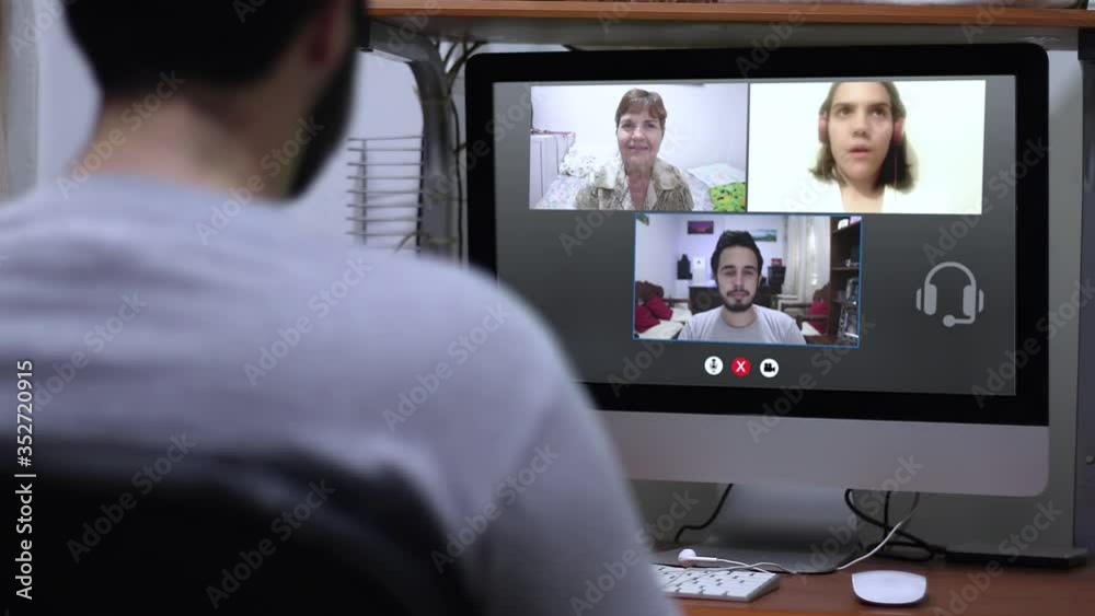 Man makes a video call, talking to two women who are far away, using ...