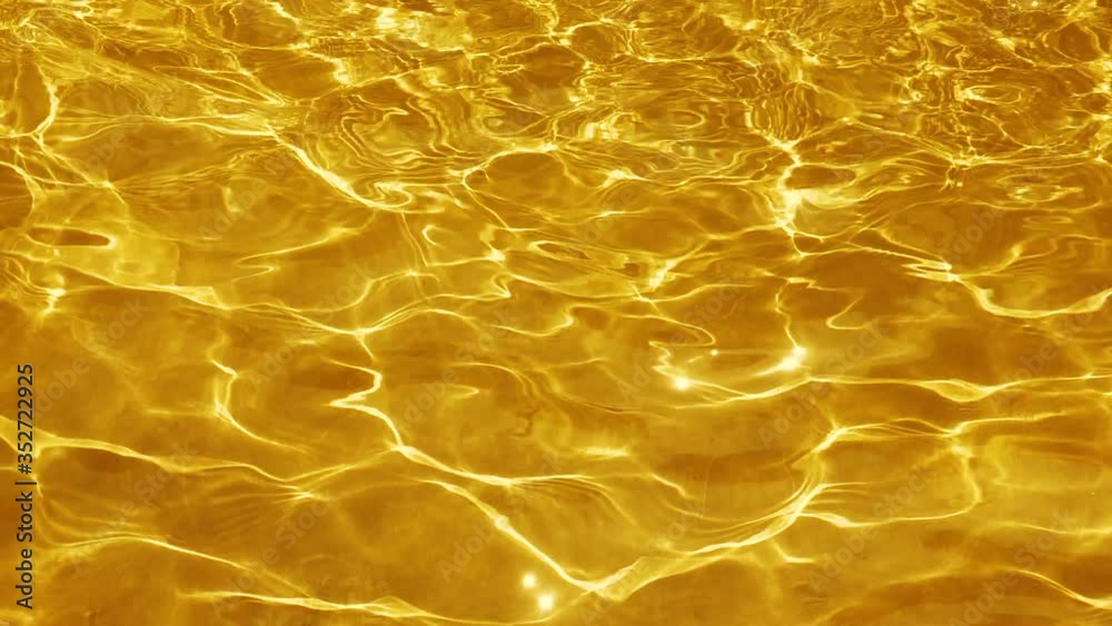 abstract gold water surface background with wave and light reflections ...
