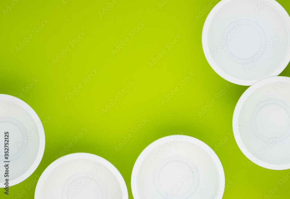 biodegradable food containers on a green background, space for text ...