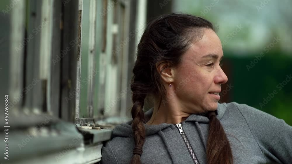 close-up portrait of a dark-haired middle-aged woman with two braids on ...