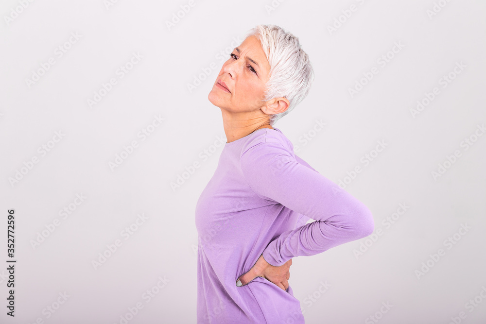 Matur Woman suffering from lower back pain. Mature woman resting with ...