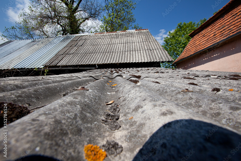 Dach z azbestu, blachy i dachówki. Stock Photo | Adobe Stock