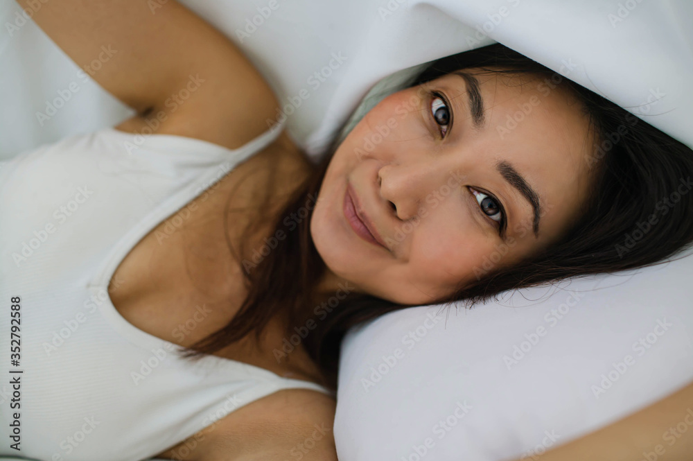 Pretty Young Asian Woman Sleeping In Bed with white sheets. Stock Photo ...