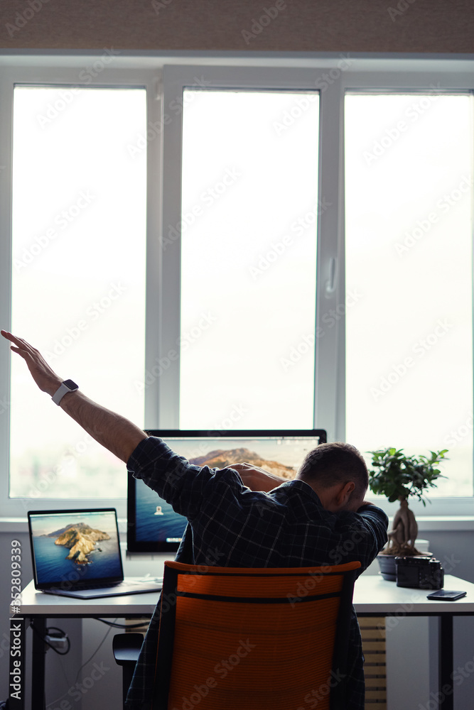 Foto de Back view portrait of a successful man, who is celebrating at ...