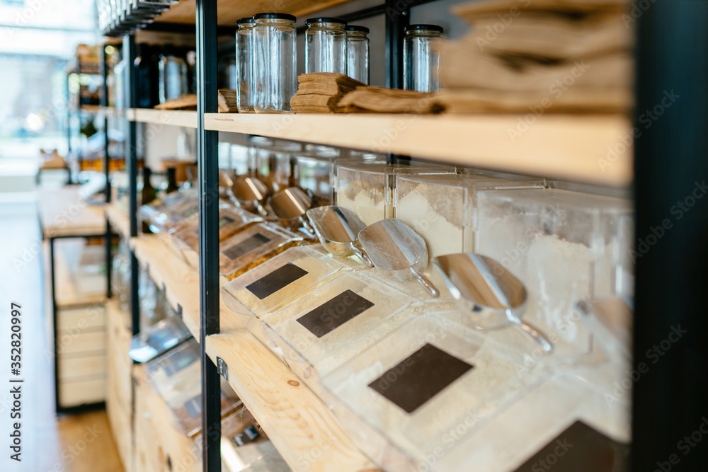 Zero waste shop interior details. Wooden shelves with different food ...