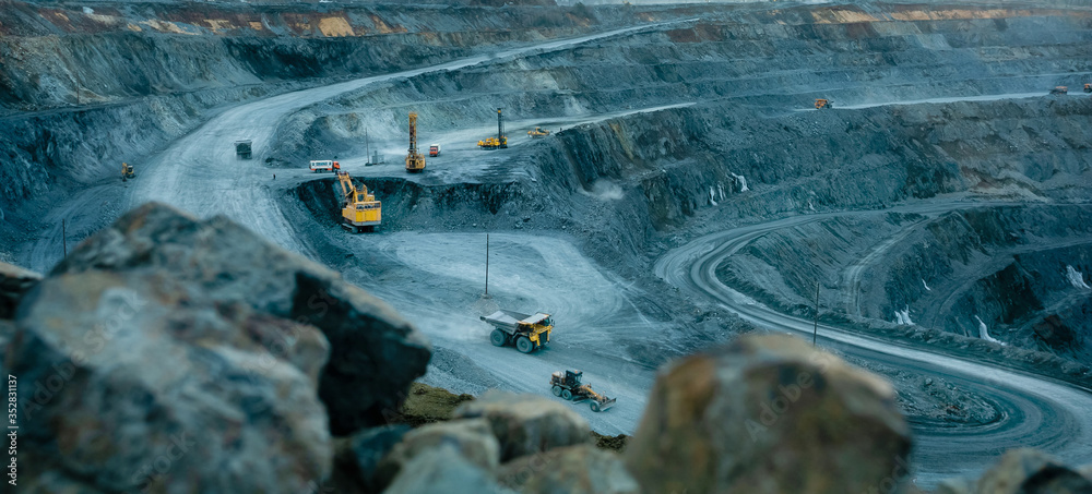 Work of trucks and the excavator in an open pit Stock Photo | Adobe Stock