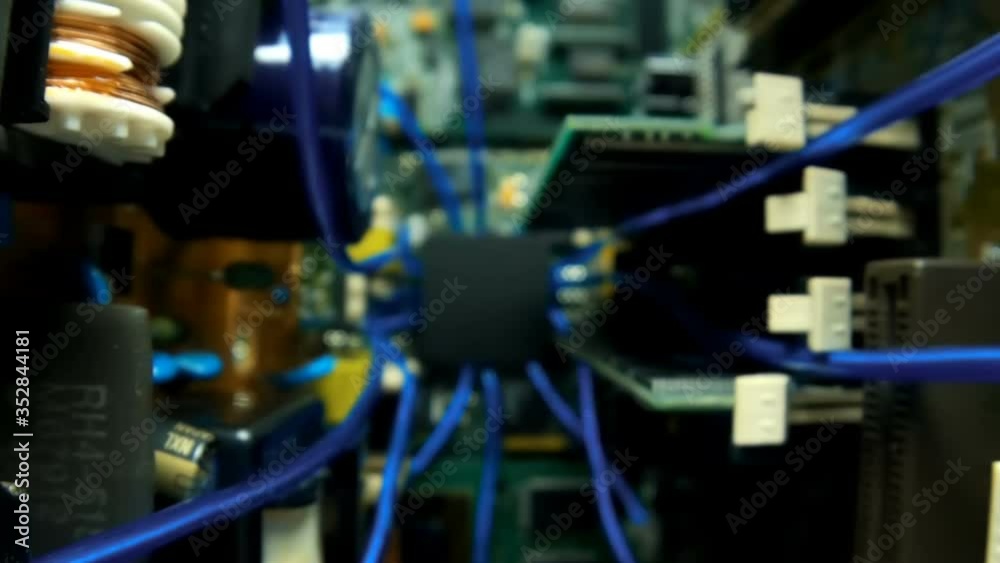 The camera slowly moves between two printed circuit boards to the main ...
