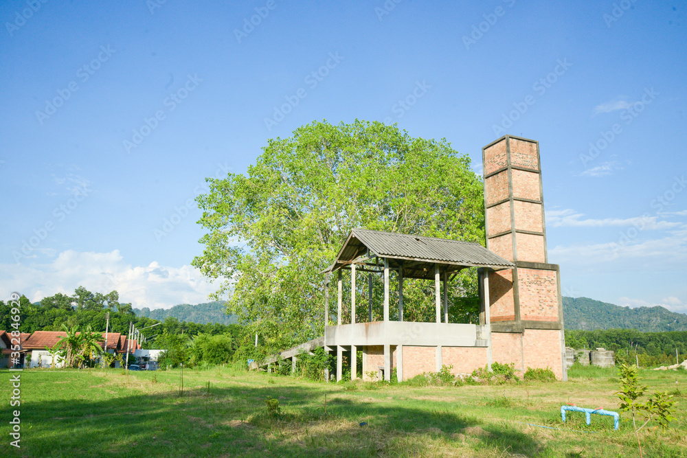 Old waste incinerator, abandoned With a large tree growing beside Stock ...