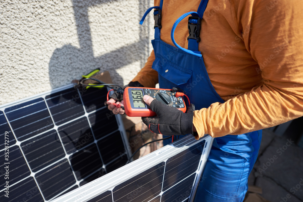 Man engineer installing solar photovoltaic panel system on roof of ...