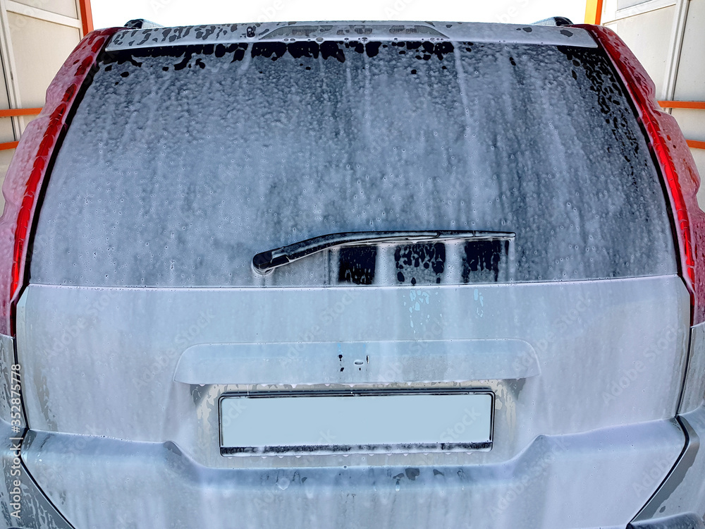 rear trunk lid with window wiper blade coated with detergent active ...