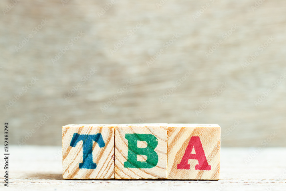 Alphabet letter in word TBA (abbreviation of to be announced) on wood ...