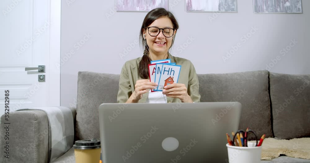 Young woman teacher showing pictures with the alphabet, learning ...