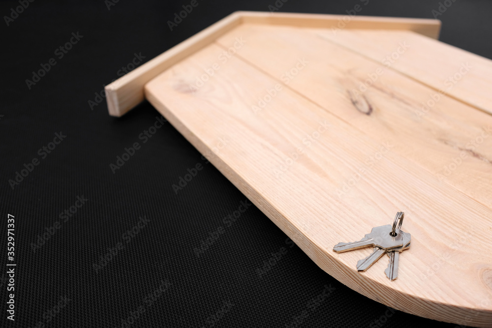Blank Wood House with keys on black background. Concept sale ...