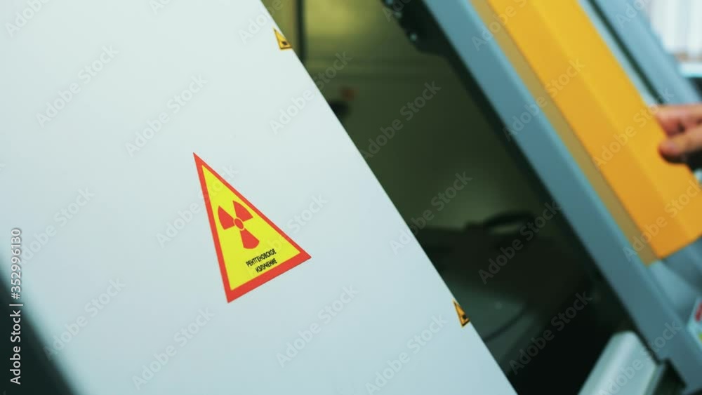 Laboratory assistant places the chip in an X-ray scanner to detect ...