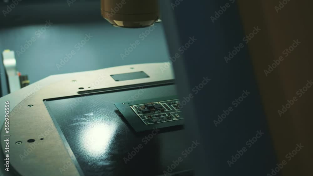 Laboratory assistant places the chip in an X-ray scanner to detect ...