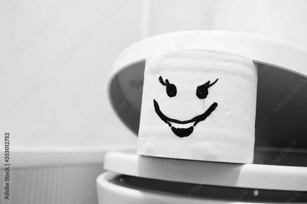 Roll of toilet paper with drawn face in restroom Stock Photo | Adobe Stock