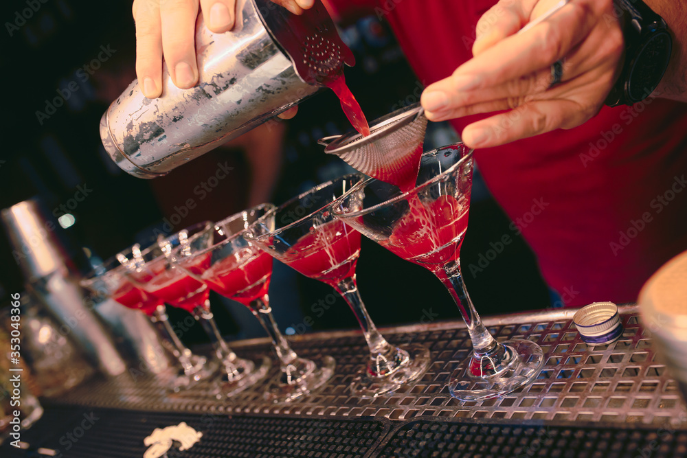Bartender pouring using strainer White healthy Cocktail drink on a bar ...