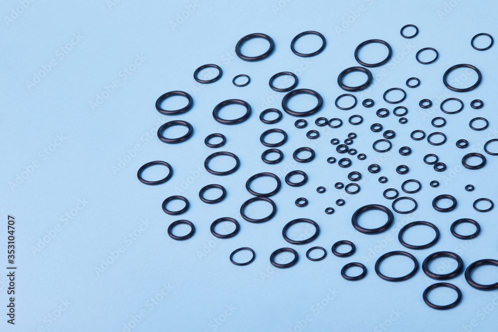 Black hydraulic and pneumatic o-ring seals of different sizes a blue ...