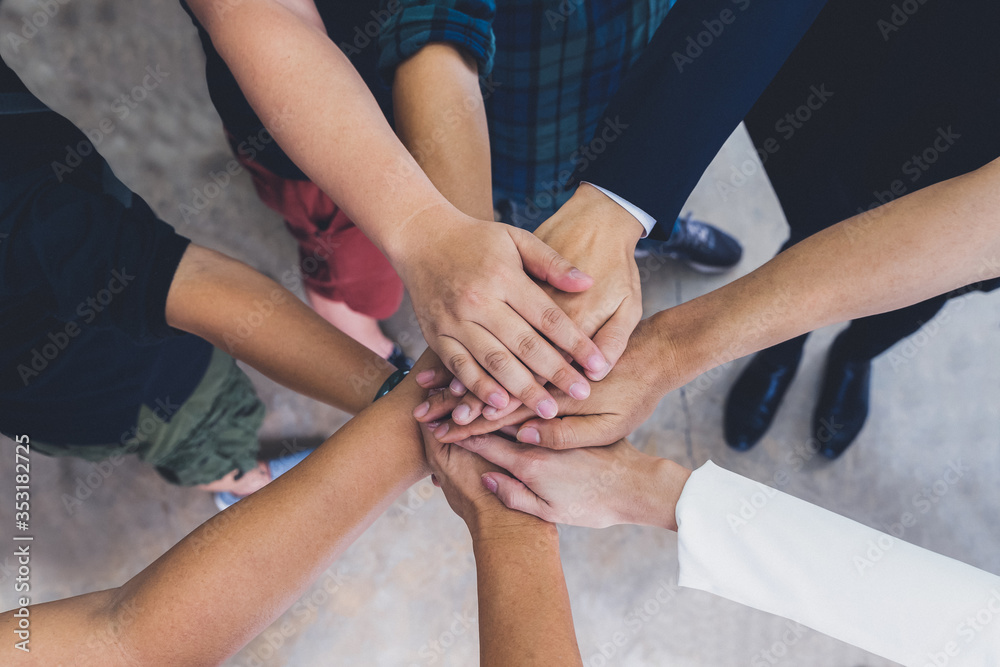 Top view of young business people join hand together during their ...