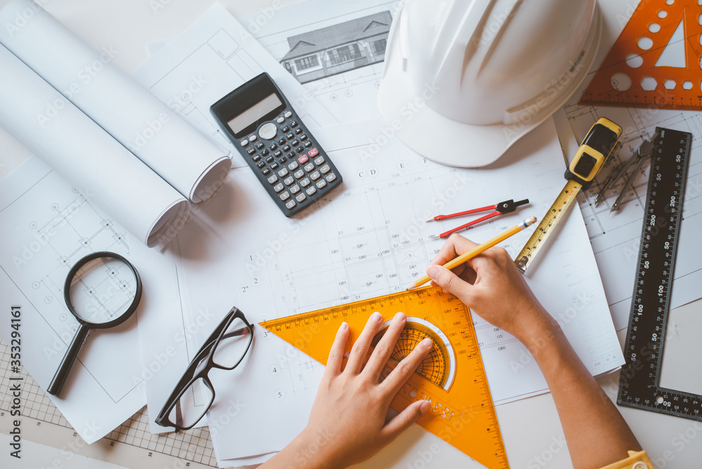 engineer working in office with blueprints, inspection in workplace for ...