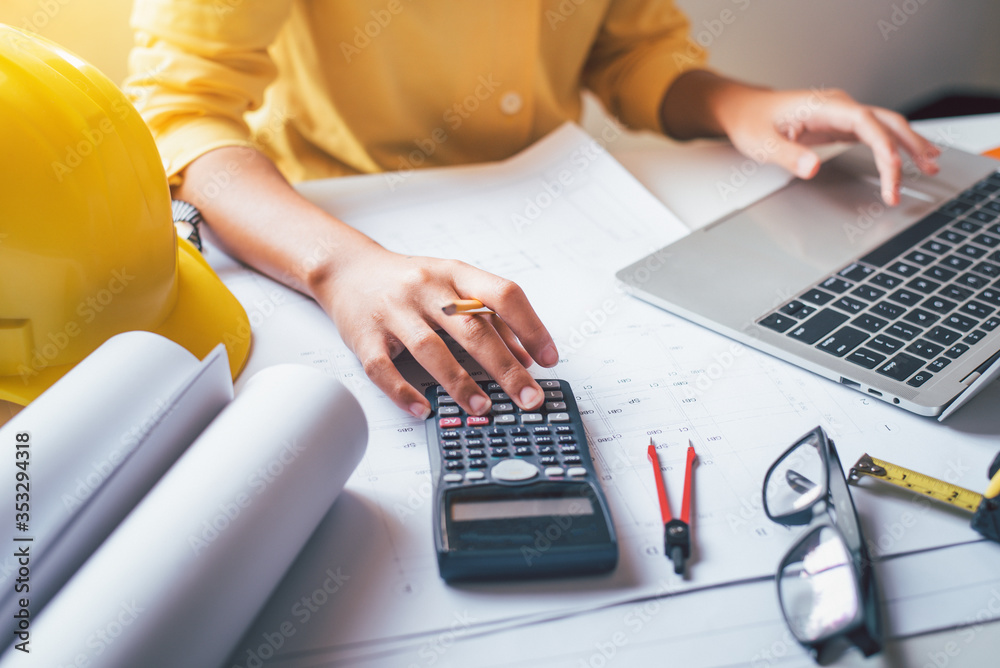 engineer working in office with blueprints, inspection in workplace for ...