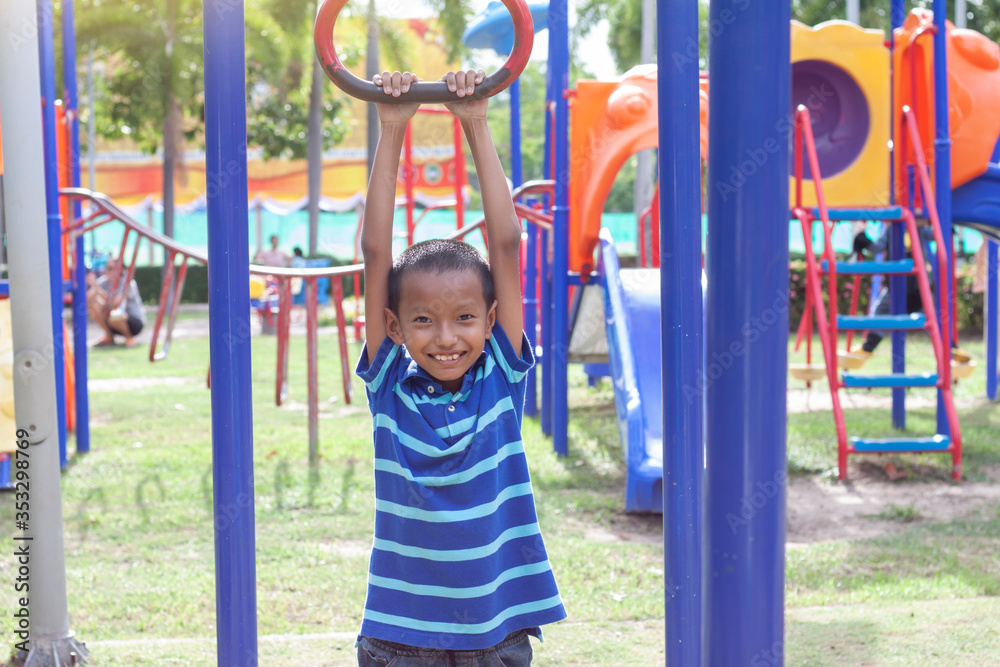 Asian boy playing monkey bars in the playground with fun. Stock Photo ...