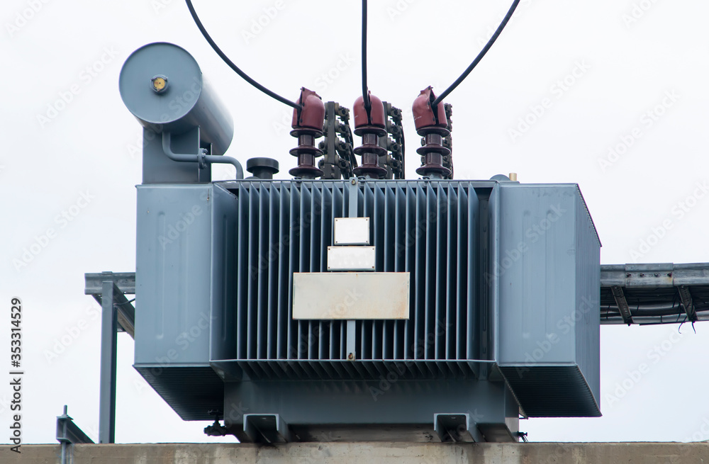 Electrical energy transformer on concrete pole changing high voltage ...