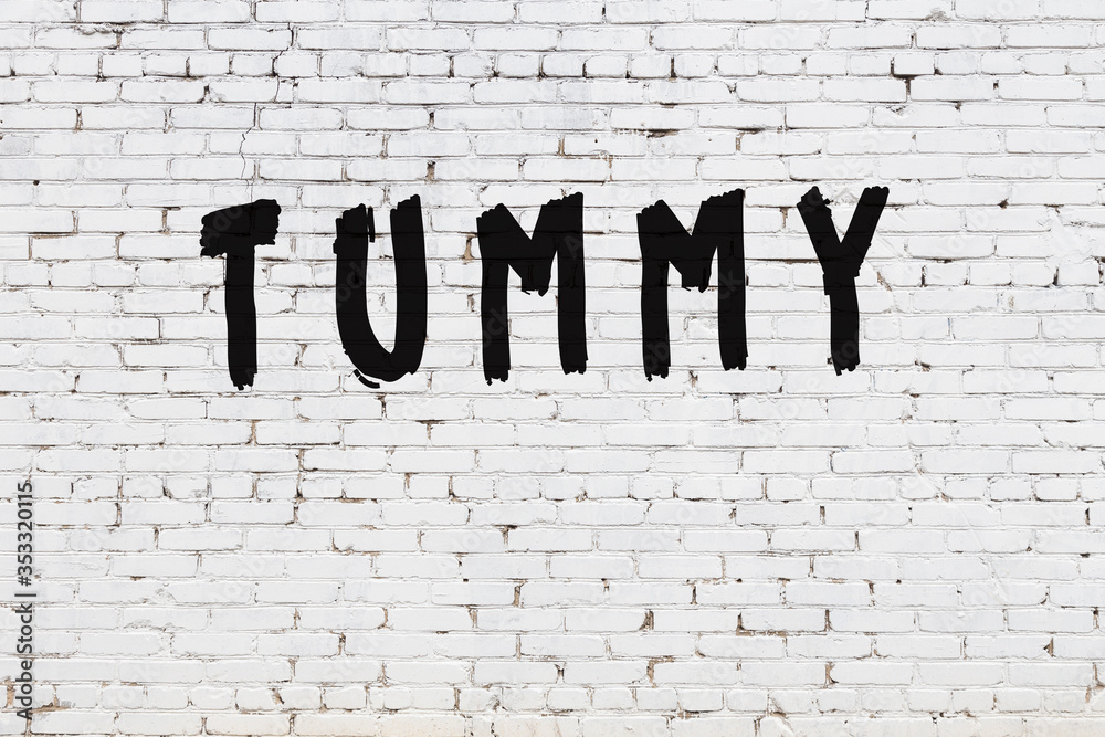 Word tummy painted on white brick wall Stock Illustration | Adobe Stock