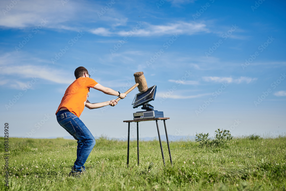 young man hitting a computer screen with a big gavel Stock Photo ...