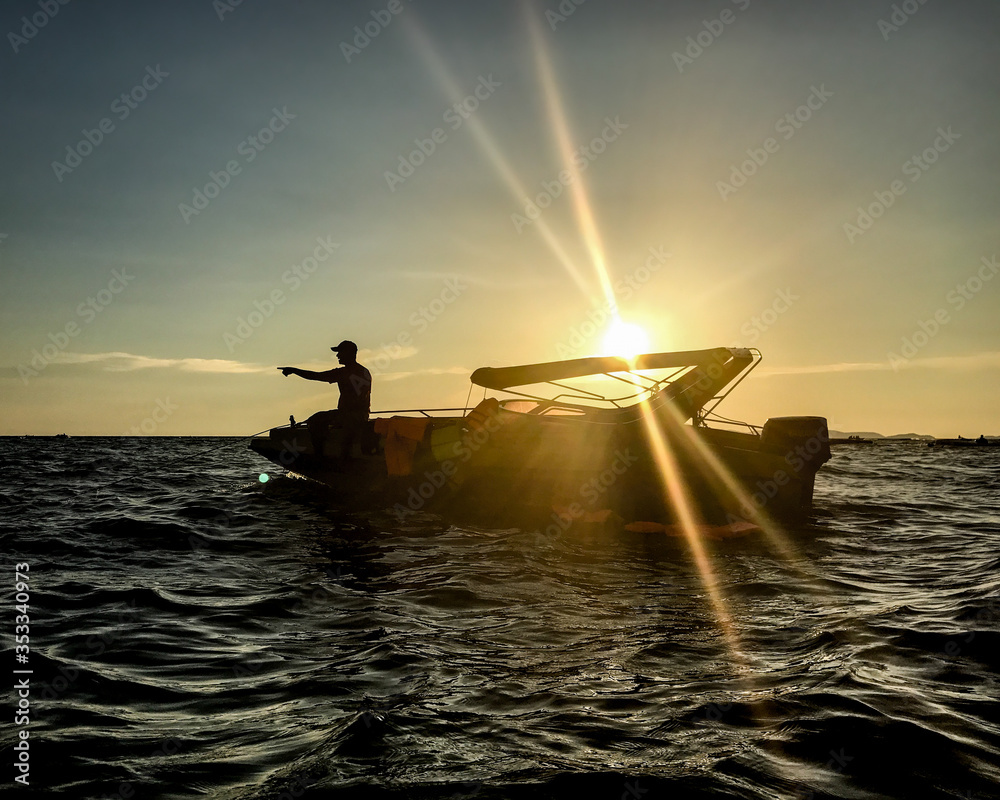 Pointing man on boat sunset silhouette in Pattaya, Thailand Stock Photo ...