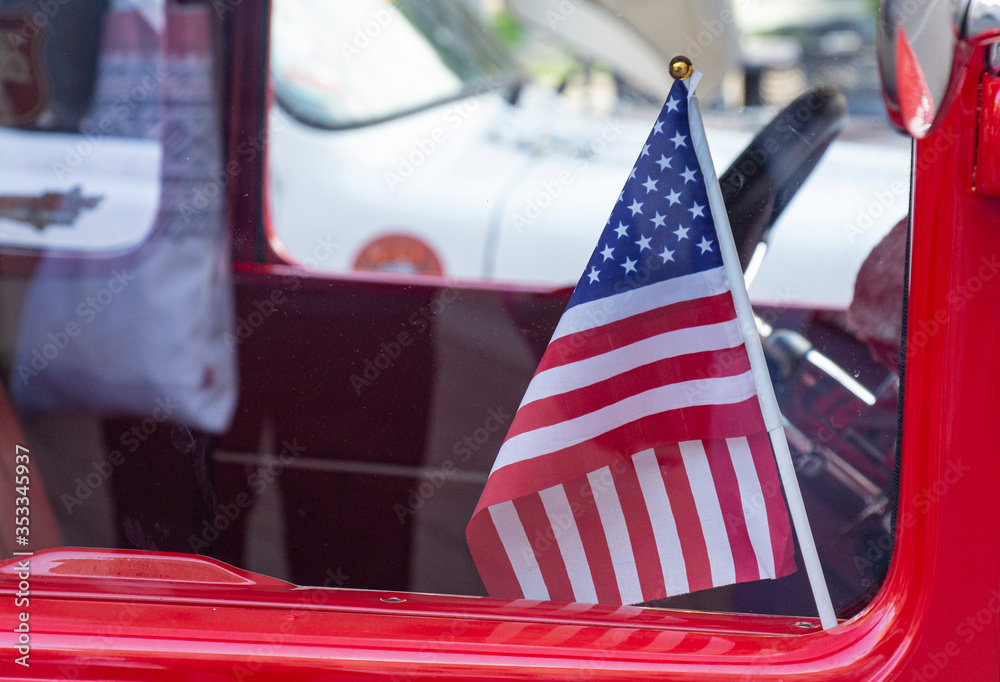 USA flag small in red car behind glass Stock Photo | Adobe Stock