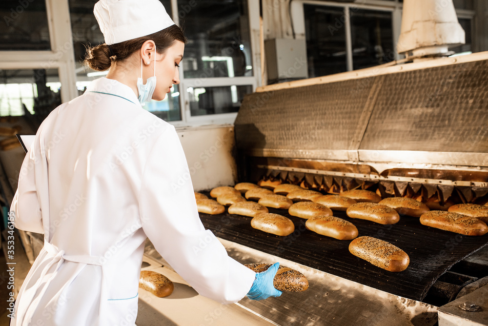 Bread. Bread production line. Girl in uniform. Sanitary check. Bakery ...